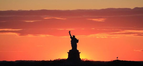 statue of liberty and sun